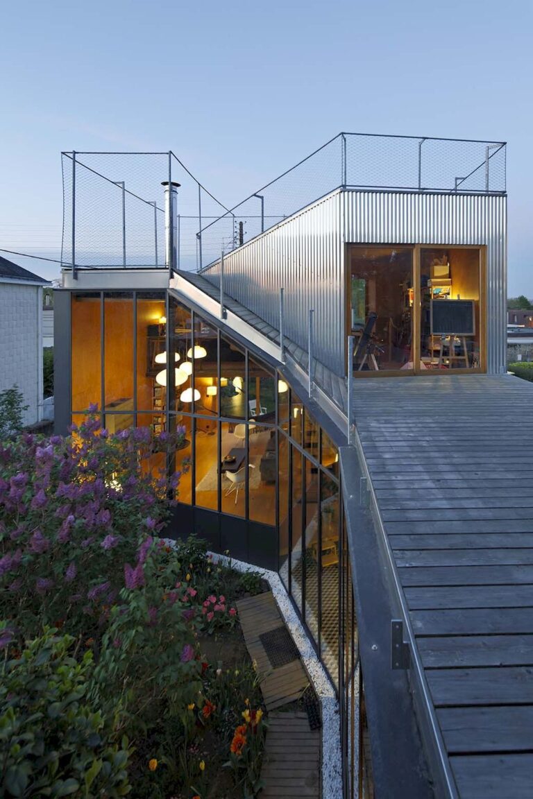 Landscape House features metal wall, sloping roof terrace by Mabire Reich